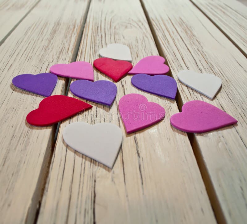 Different Colored Hearts on a Wooden Table Stock Photo - Image of ...