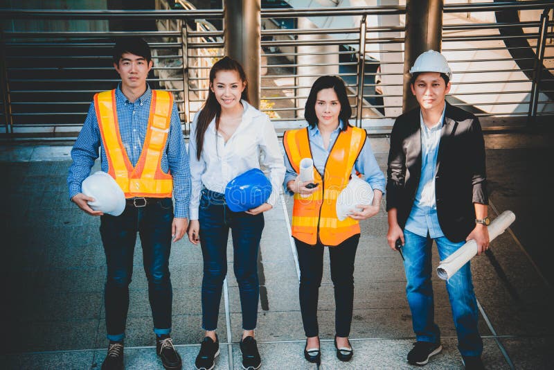 Groups of Construction Engineers or Workers with Team Construction Asian Worker. Use Blueprint ...