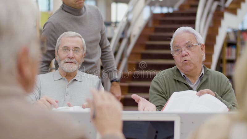 Groups of Senior People Disputing during Class in Library Stock Footage ...