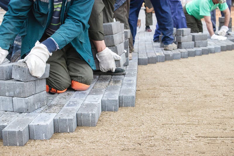 Volunteers Constructing a Pathway Using Concrete Blocks during a ...