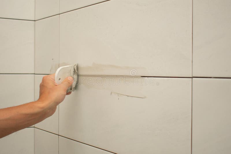 Grouting Ceramic Tiles with a Spatula Stock Photo - Image of ...