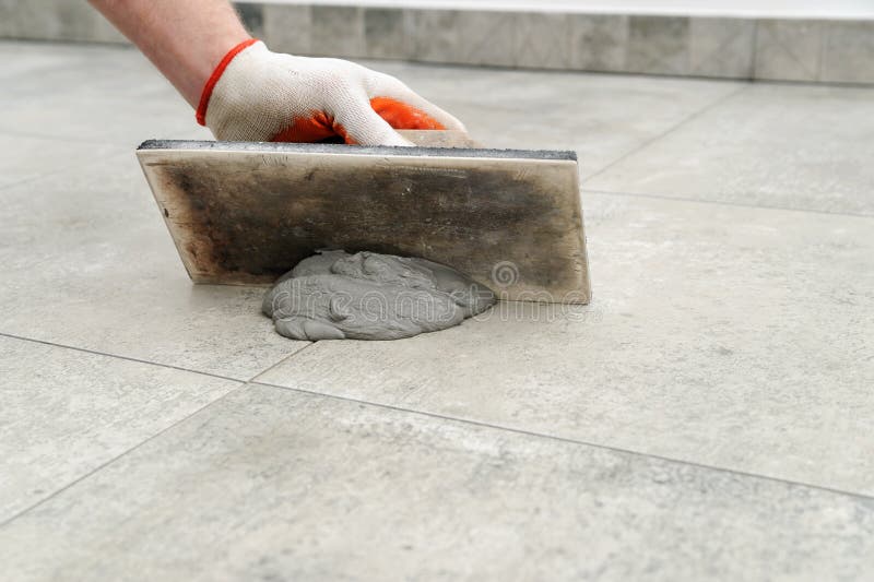 Grouting ceramic tiles. stock photo. Image of worker - 75883992