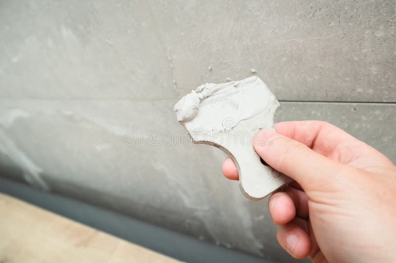 Grouting Ceramic Tiles Using a Fugue. Worker Putting Fugue on Tiles ... Grouting Ceramic Tiles Using a Fugue. Worker Putting Fugue on Tiles ...