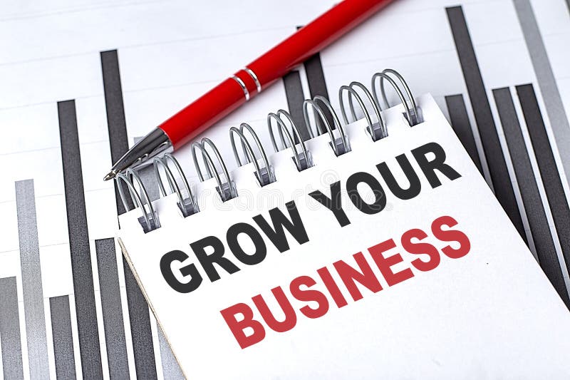 GROW YOUR BUSINESS Text Written on Notebook with Pen on Chart Stock ...