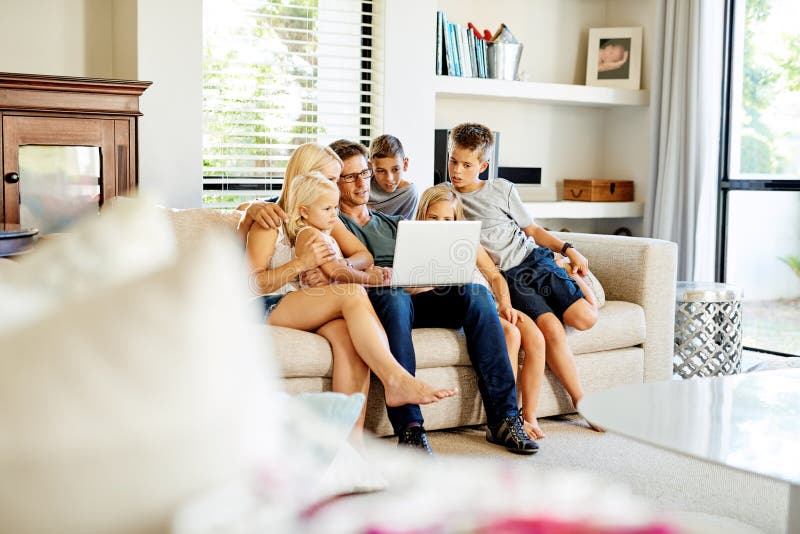 Discovering the Wonders of Technology Together. a Family Using a Laptop ...