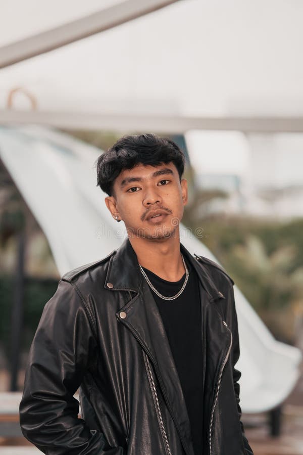 A Grown Man in a Black Leather Suit and Chain Necklace Posing Very ...