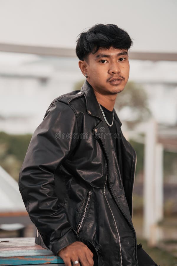 A Grown Man in a Black Leather Suit and Chain Necklace Posing Very ...