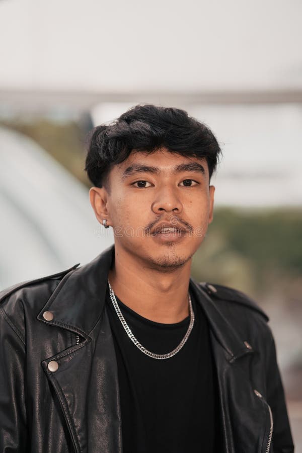 A Grown Man in a Black Leather Suit and Chain Necklace Posing Very ...