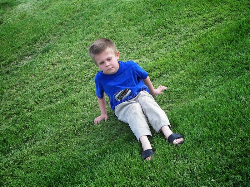 Grumpy kid in grass stock image. Image of upset, child - 5430239