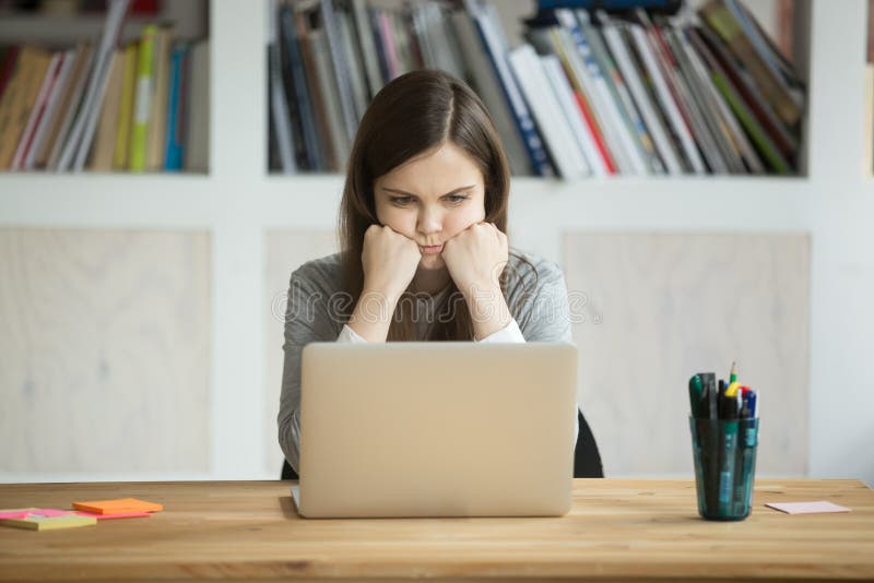 Grumpy Not Amused Office Worker Looking at Laptop Screen. Stock Photo ...