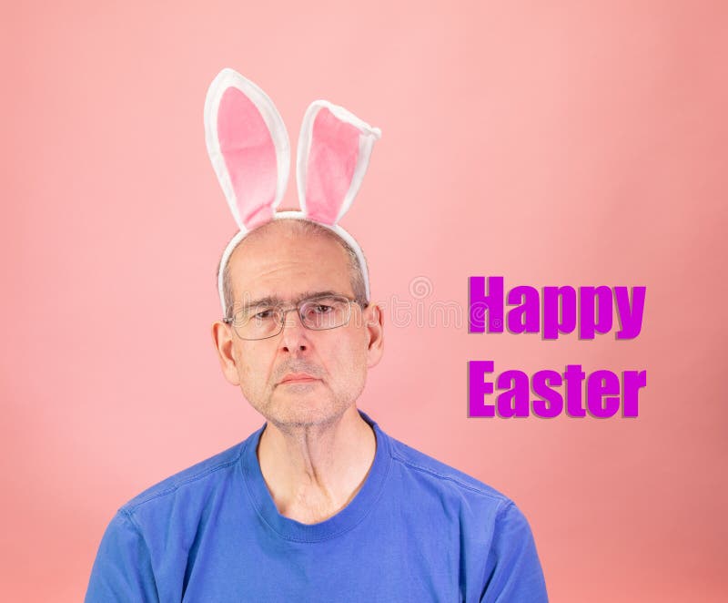Grumpy Old Man with Easter Bunny Ears Looks Deadpan at the Camera Stock ...