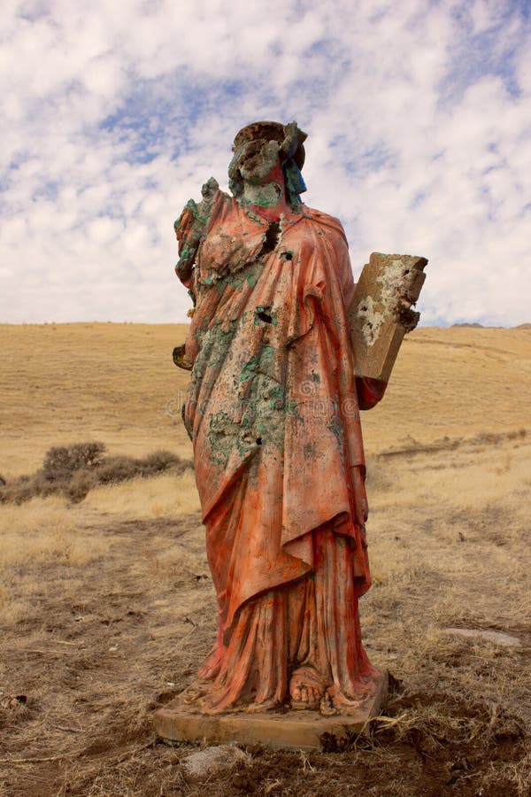 Religious statue on a rock stock image. Image of rock - 334716023