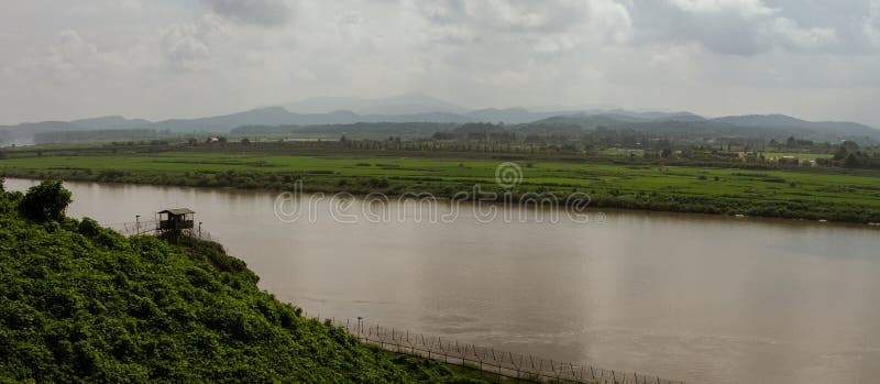 Guard Post Overlooking Tranquil River and Green Fields with Mountain ...