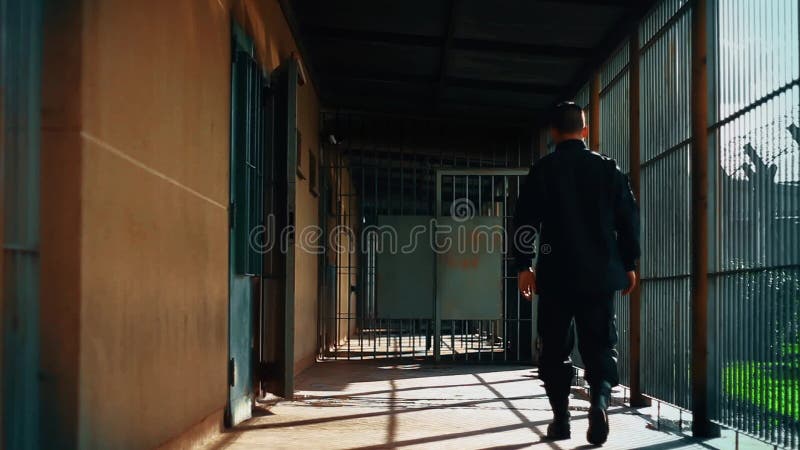 Guard Walking through Prison Hallway Stock Video - Video of criminal ...