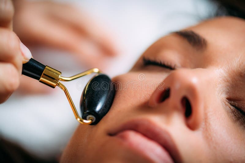 Guasha Face Massage with Jade Stone Roller Stock Photo - Image of ...