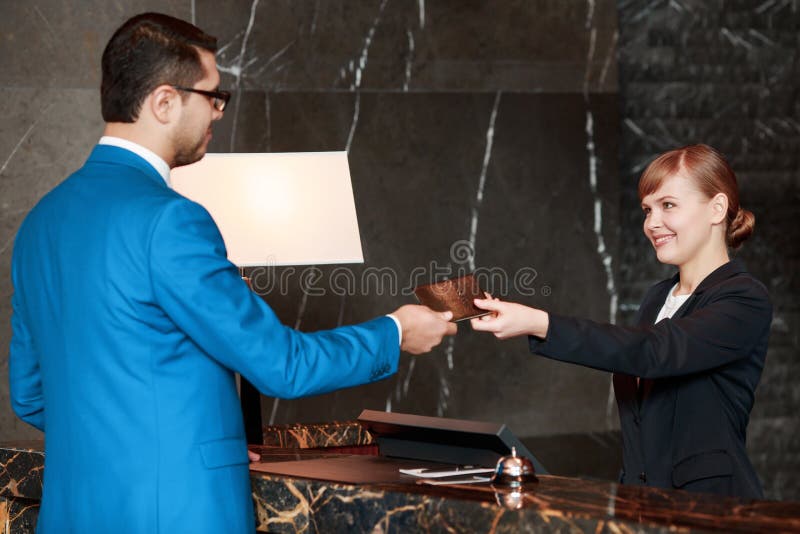Guest Communicating with a Receptionist Stock Photo - Image of ...