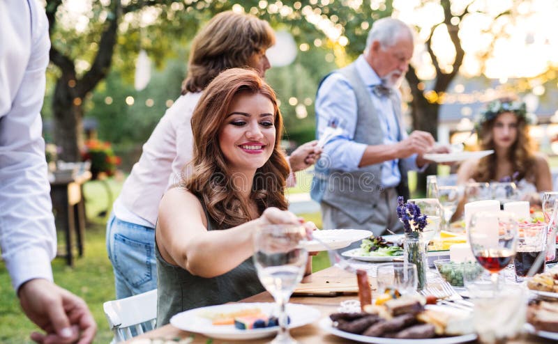 Guests Eating at the Wedding Reception Outside in the Backyard. Stock ...