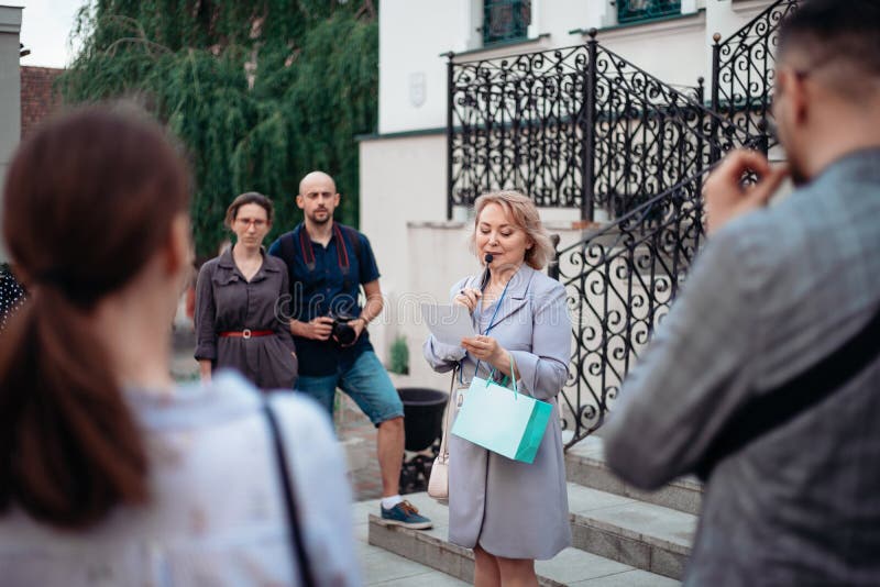 Guide and a Group of Tourists Standing on the Steps of the Hotel. Stock ...