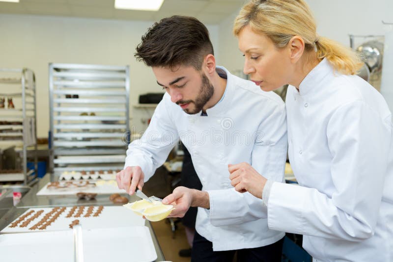 Guiding Chocolatier Apprentice in Molding Stock Photo - Image of ...