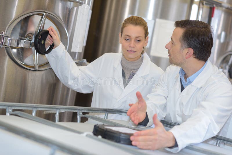 He guiding colleague stock image. Image of production - 239075445