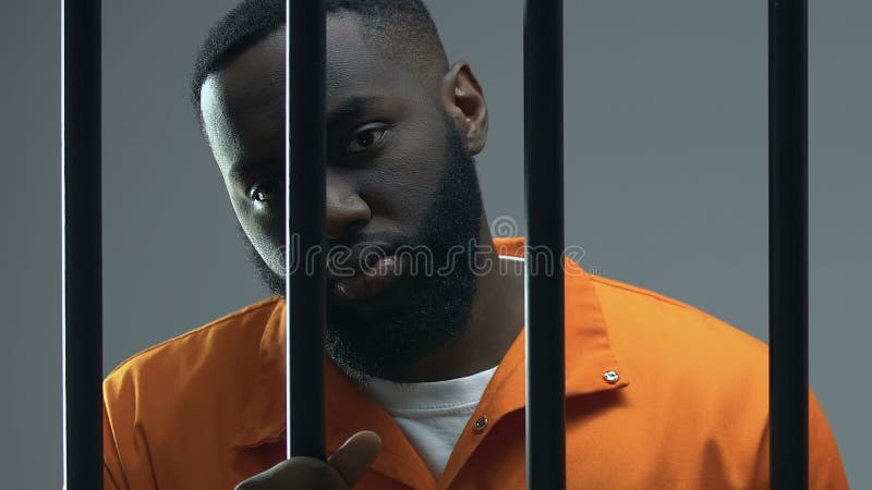 Criminal Looking Out from Prison Cell through the Jail Bars Closeup ...