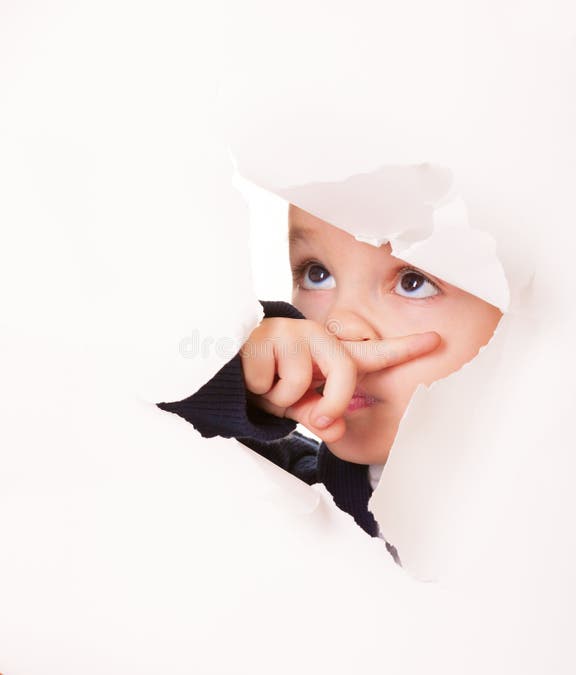 Guilty Looking Kid in a Hole in White Paper Stock Photo - Image of ...