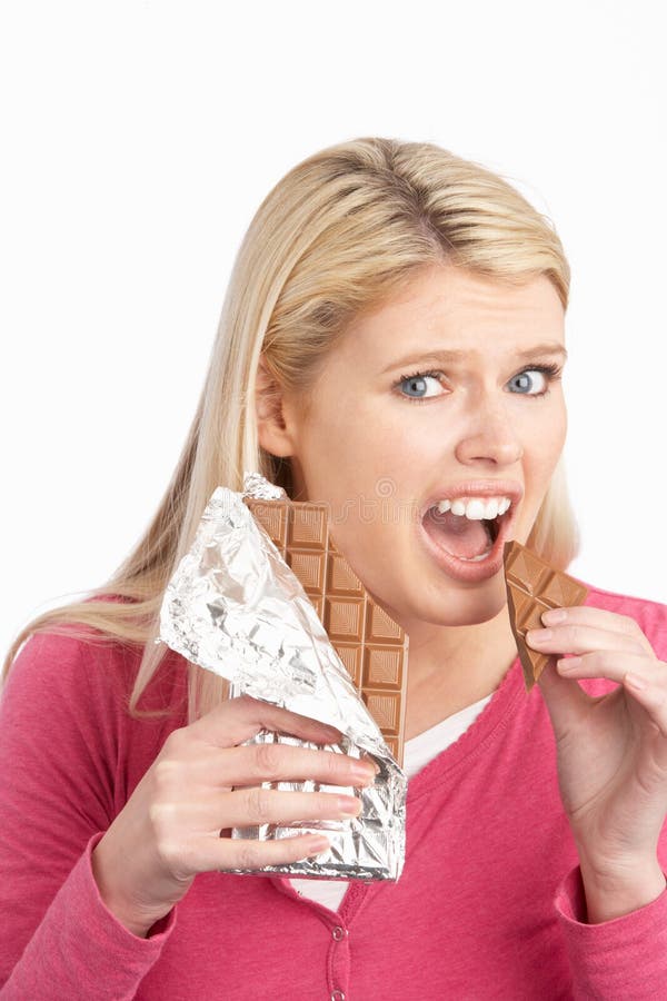 Guilty Looking Young Woman Eating Stock Photo - Image of expression ...