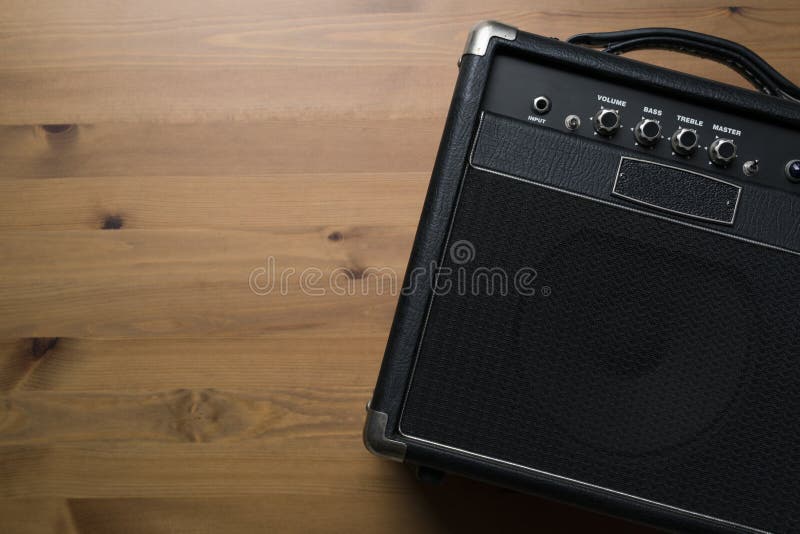 Guitar Amplifier and Guitar on Wood Table Stock Photo - Image of ...