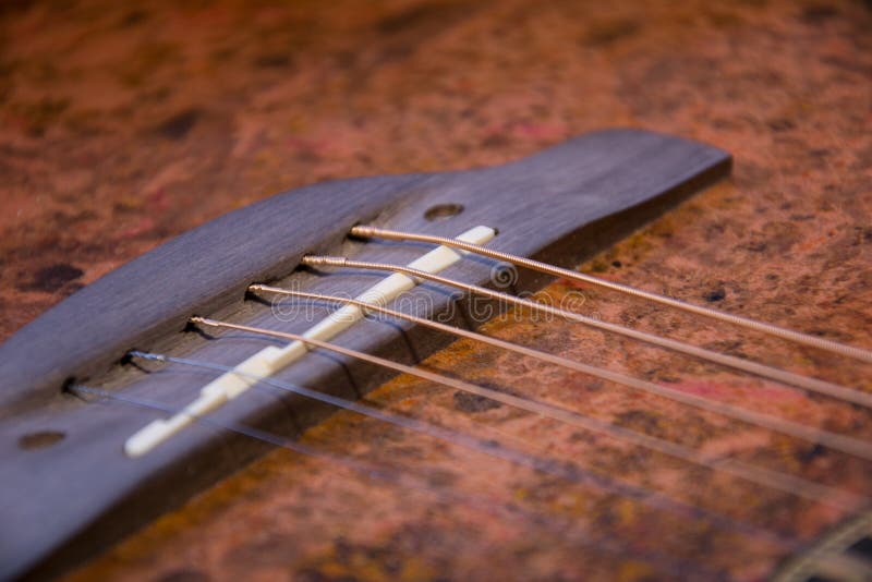 Guitar bridge with strings stock image. Image of string - 84745861