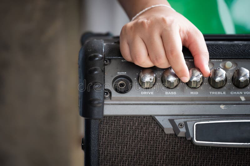 Guitar Electric Amplifier. Rock Overdrive Effect. Hand is Plugging a ...