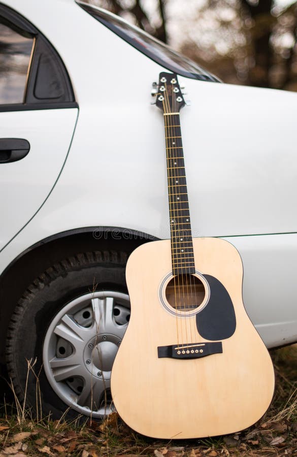 Guitar Near the Wheels of the Machine Stock Photo - Image of brown ...