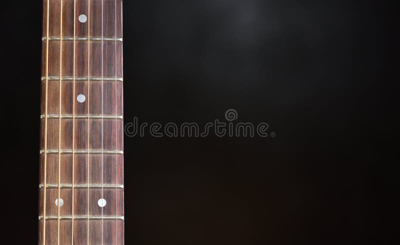 Guitar Neck and Strings Close Up on a Black Background with a Copy ...