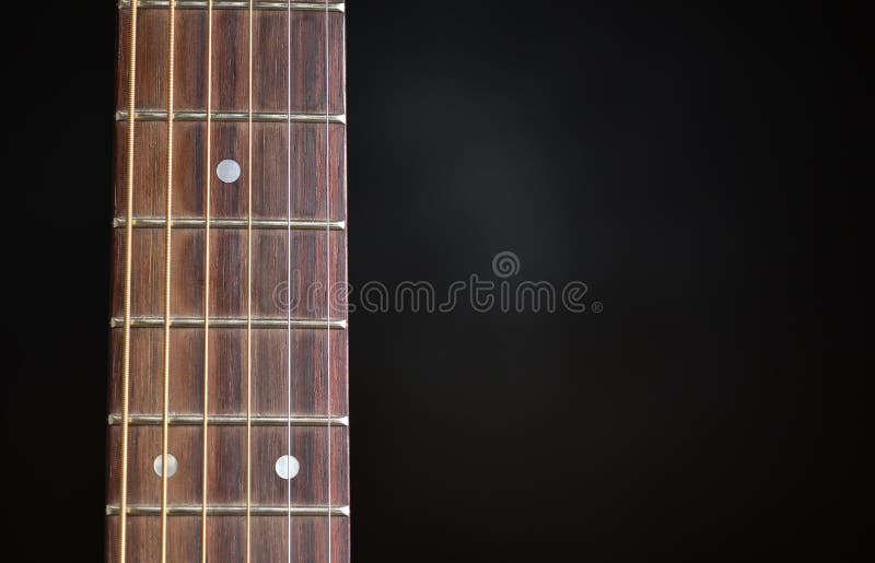 Guitar Neck and Strings Close Up on a Black Background with a Copy ...