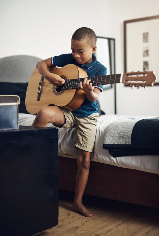 The Guitar is One of the Best Instruments for Kids. a Young Boy Playing ...