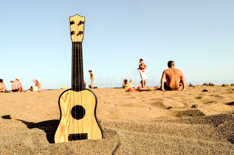 Guitar on the Sand Beach stock photo. Image of vacation - 261557004