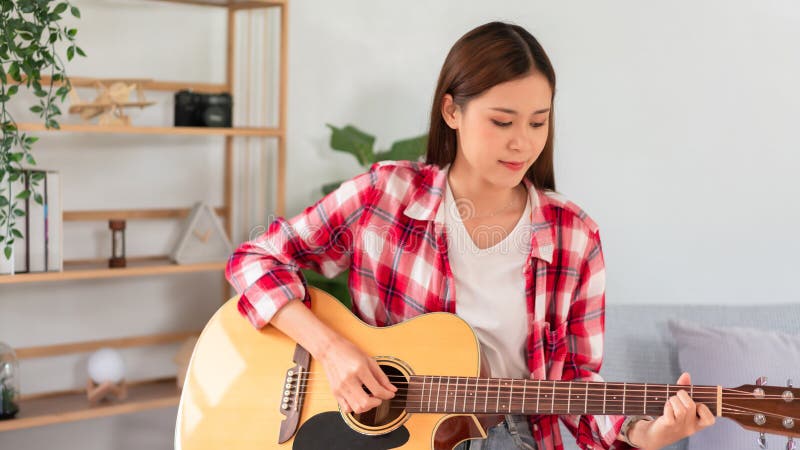 Guitar and Singer Concept, Young Woman Learning and Practice Playing Chords with Acoustic Guitar ...