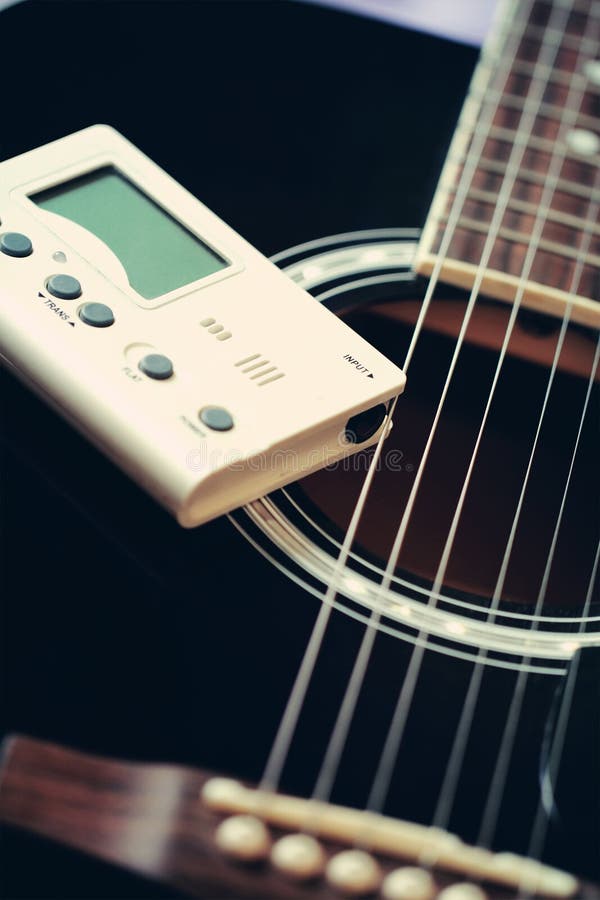 Guitar and Tuner for Musical Instruments Stock Image - Image of black ...