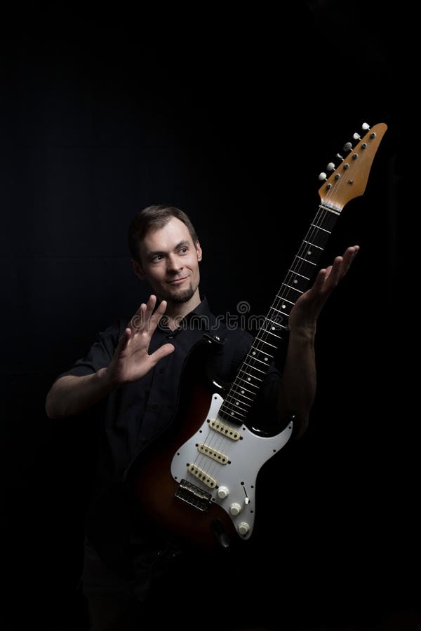 The Guitarist Masterfully Controls the Electric Guitar, Studio Portrait ...