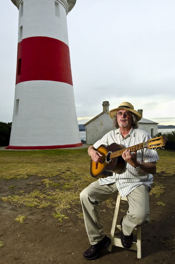 Guitarist Playing Acoustic Near Lighthouse Stock Photo - Image of ...