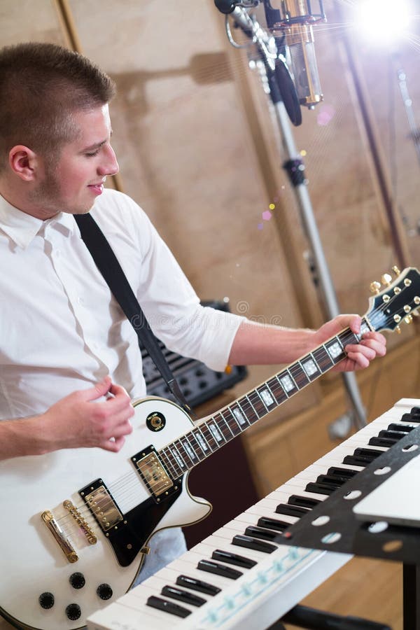 Guitarist Playing Guitar Next To the Keyboards Stock Photo - Image of ...