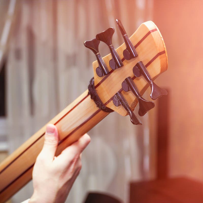 The Guitarist S Hand on the Neck of a Six-string Bass Guitar Stock ...