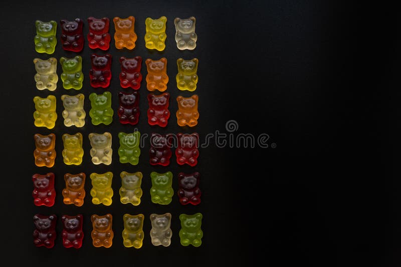 Top View of Multi-colored Gummy Bears Arranged in Rows by Color As a ...
