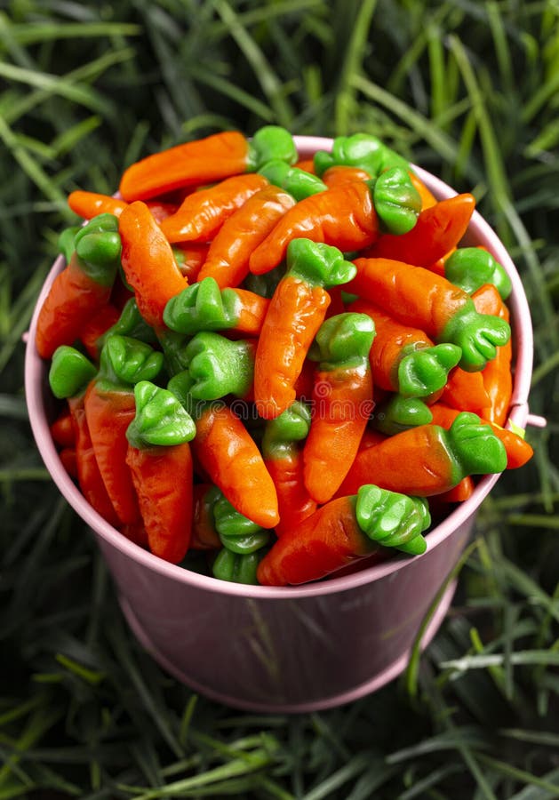 Gummy Candy Carrots in a Pink Bucket on the Grass Stock Photo - Image ...