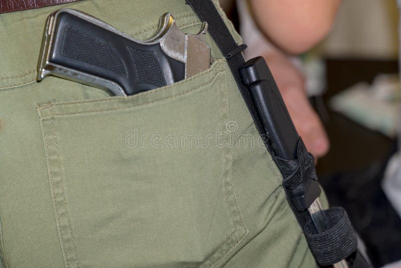 Gun in the back pocket stock image. Image of hand, buttocks - 157727655