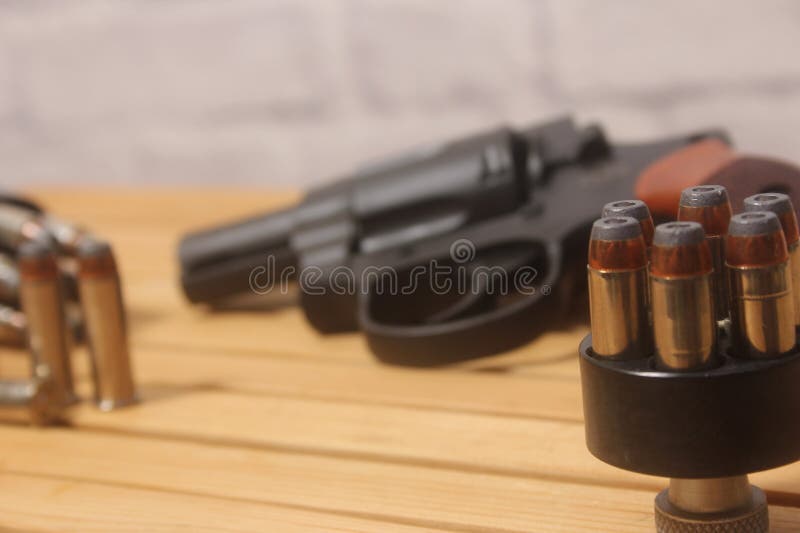 Gun and Bullets on a Wooden Table Stock Image - Image of military ...