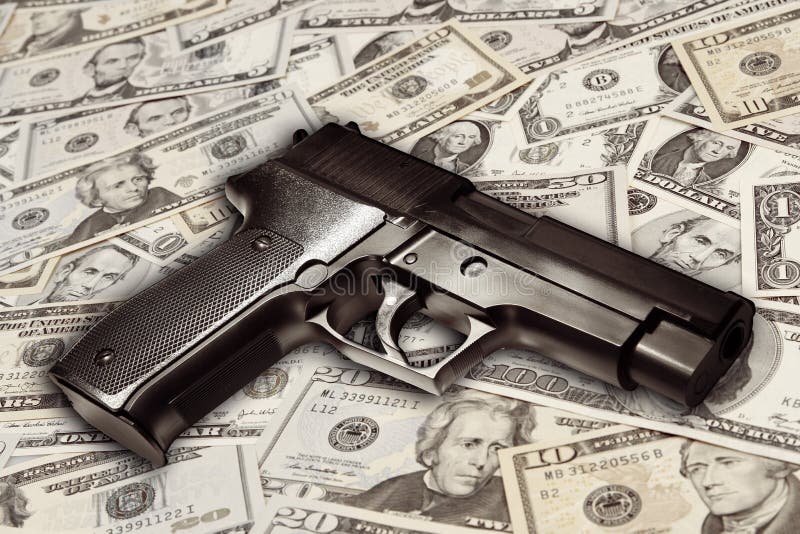 Handgun on dollar notes stock photo. Image of revolver - 20832232