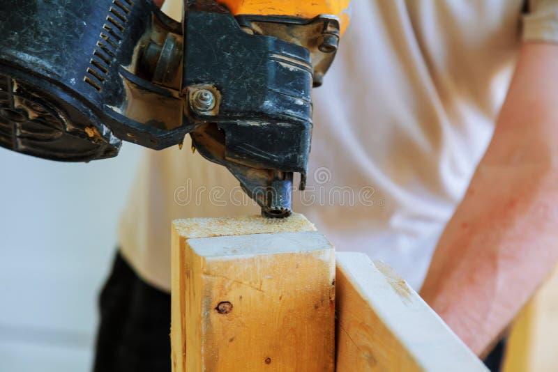 Gun Construction Shoot the Nails the Wooden Wall Stock Image - Image of ...