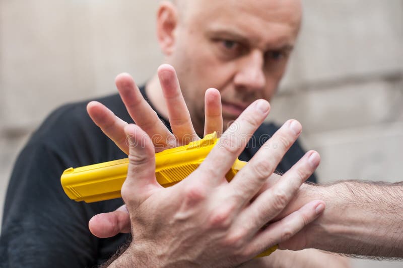 Gun Disarm. Self Defense Techniques Against a Gun Point. Stock Photo ...