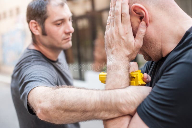 Gun Disarm. Self Defense Techniques Against a Gun Point. Stock Image ...