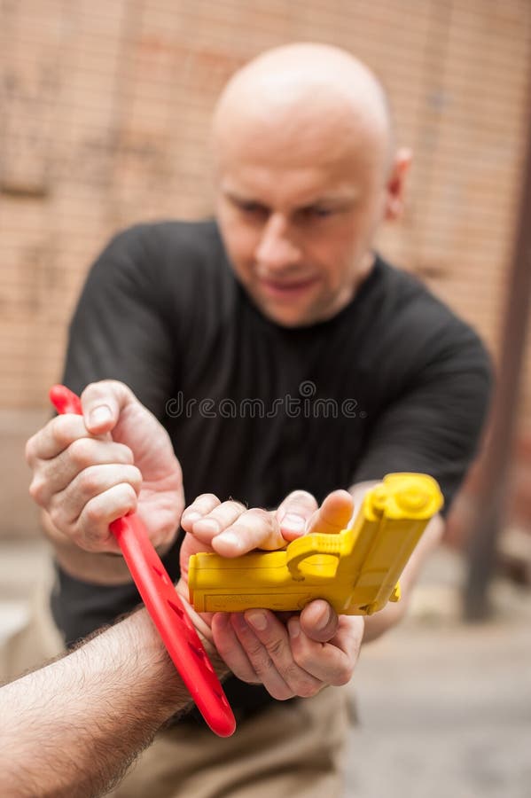Gun Disarm. Self Defense Techniques Against a Gun Point. Stock Photo ...